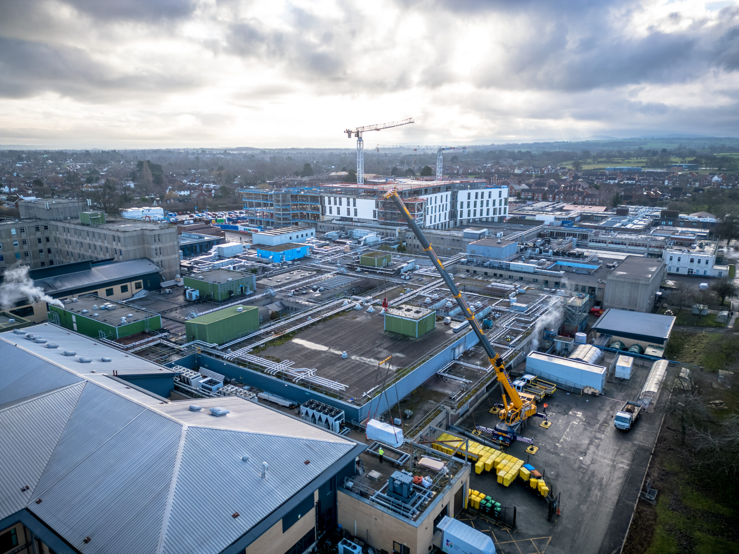 Crane lifts heat pumps onto hospital roof as part of £16.2m project – SaTH